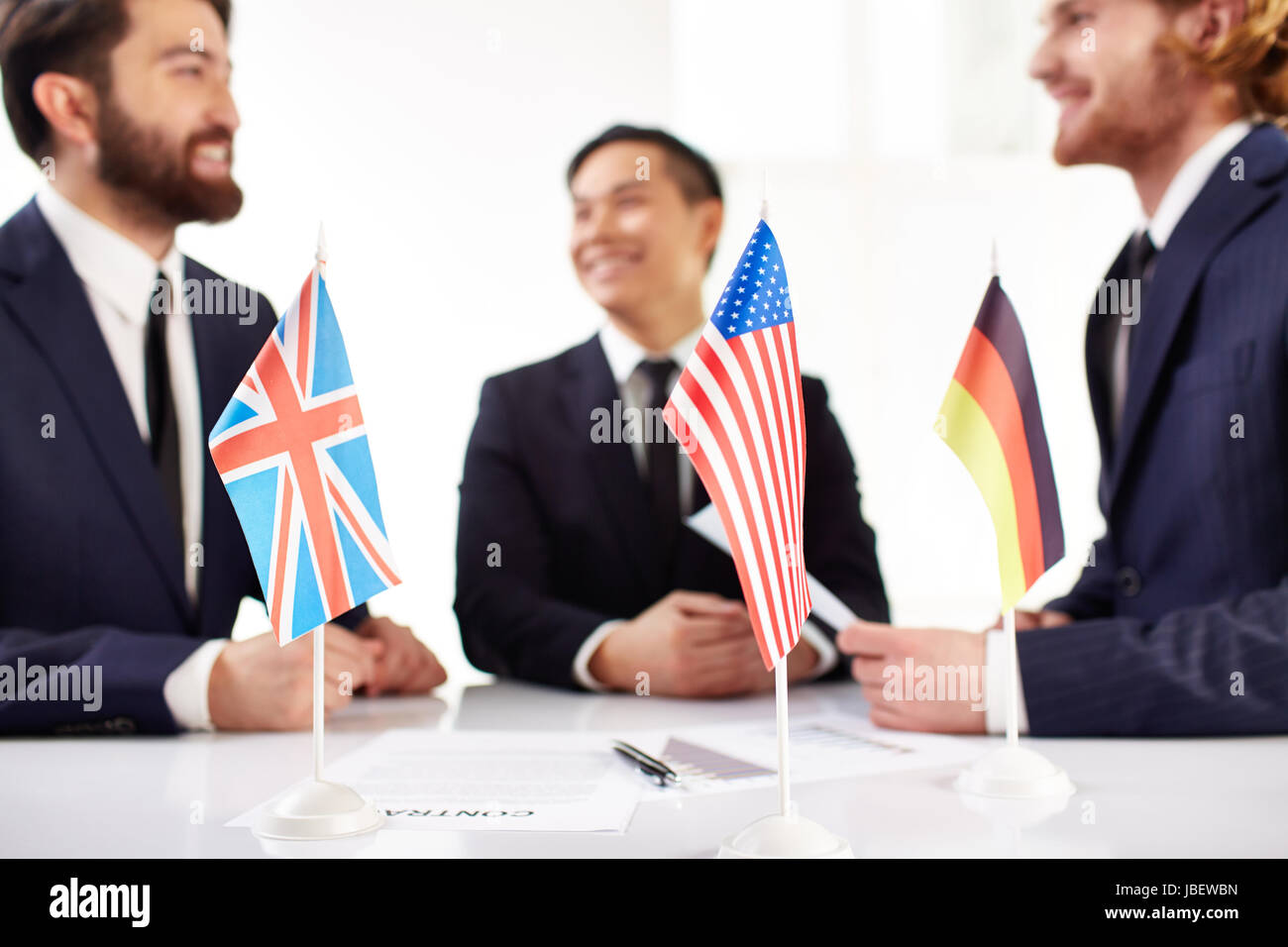 Image of American, British and German flags and business documents on ...