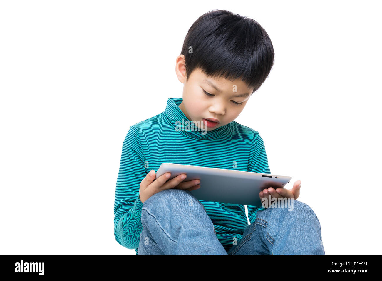 Asian little boy watching tablet Stock Photo - Alamy