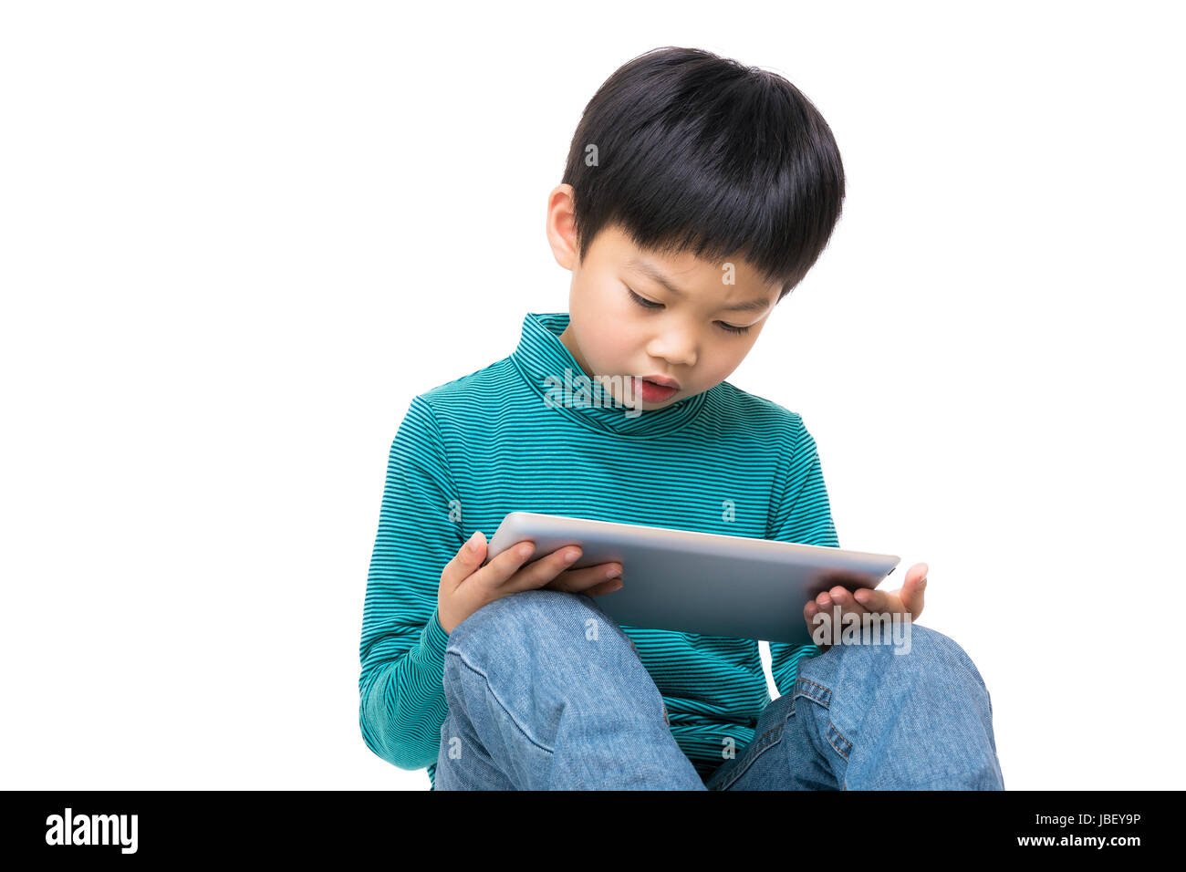 Asia little boy using tablet Stock Photo - Alamy