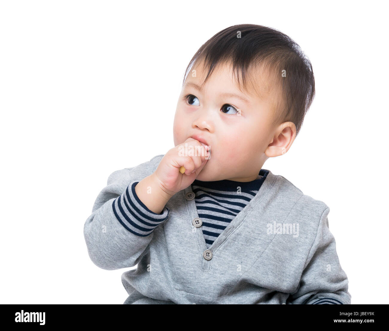 Asia baby boy eating biscuit Stock Photo - Alamy