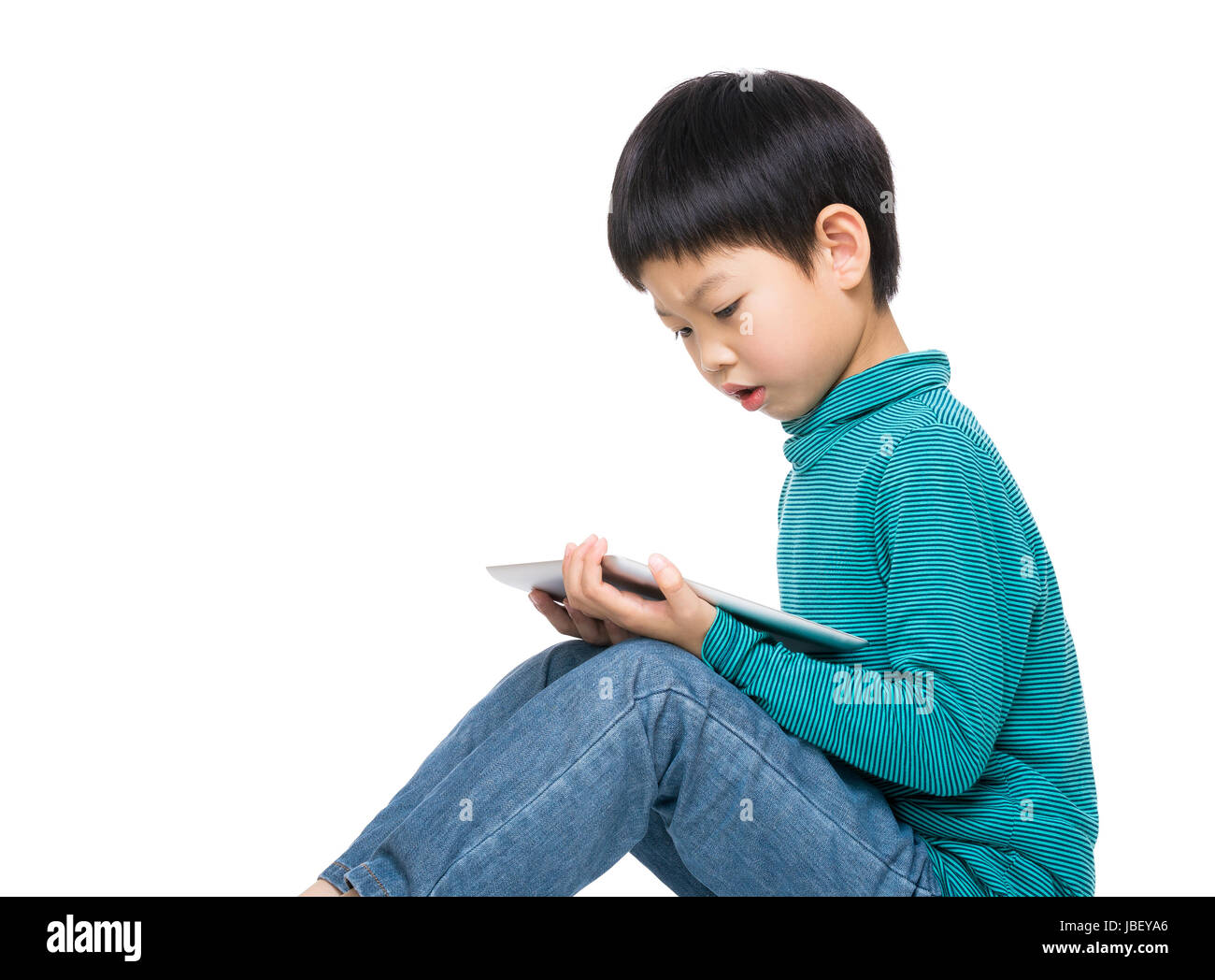 Asian little boy using tablet Stock Photo - Alamy