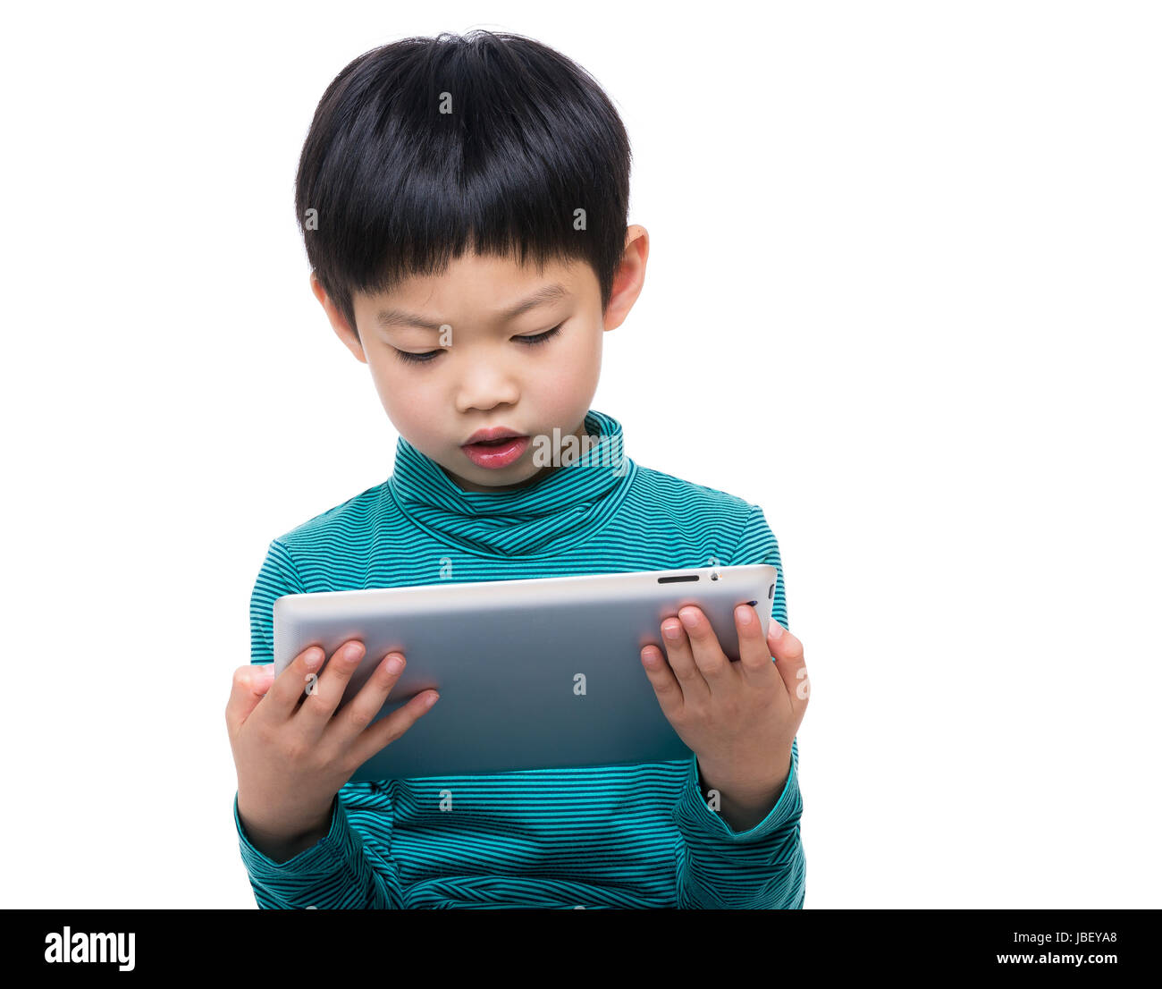 Asia little boy using tablet Stock Photo - Alamy