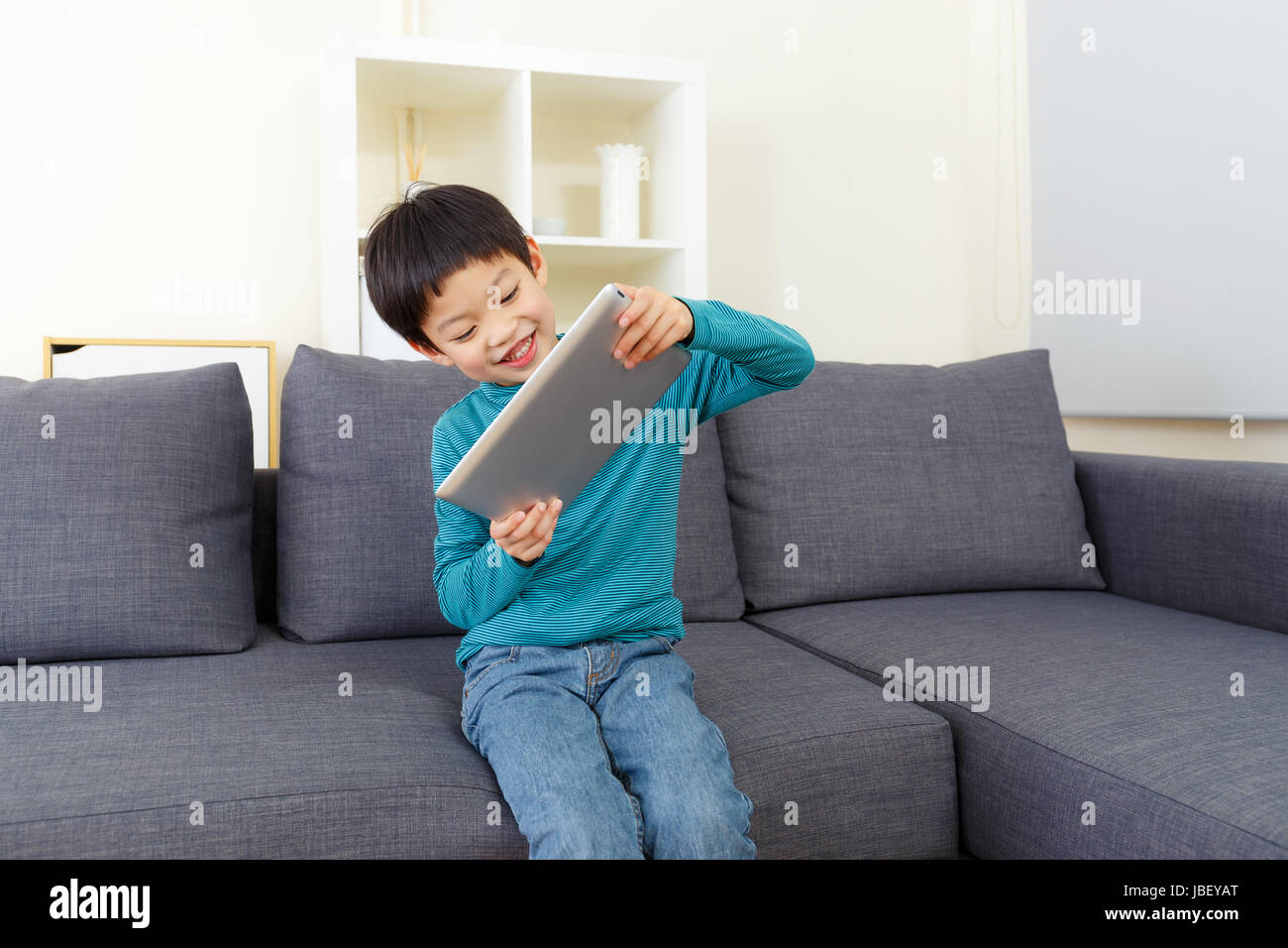 Aisa little boy play tablet at home Stock Photo - Alamy