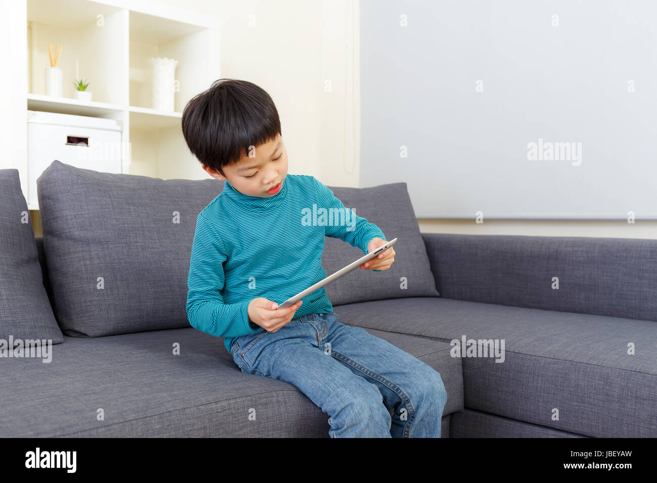 Aisa little boy play tablet Stock Photo - Alamy