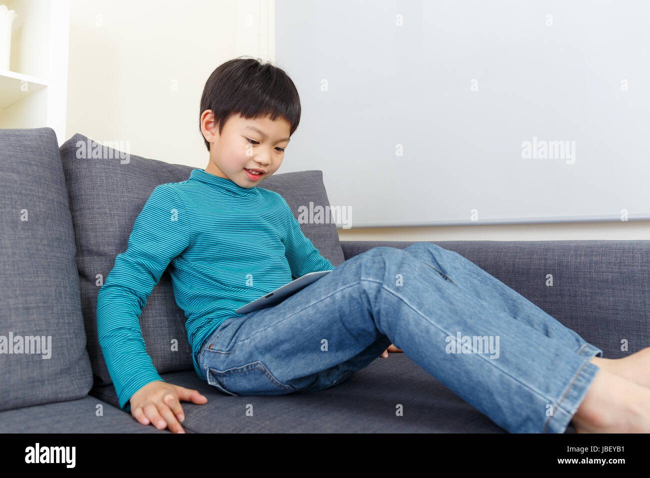 Aisa little boy play tablet at home Stock Photo - Alamy