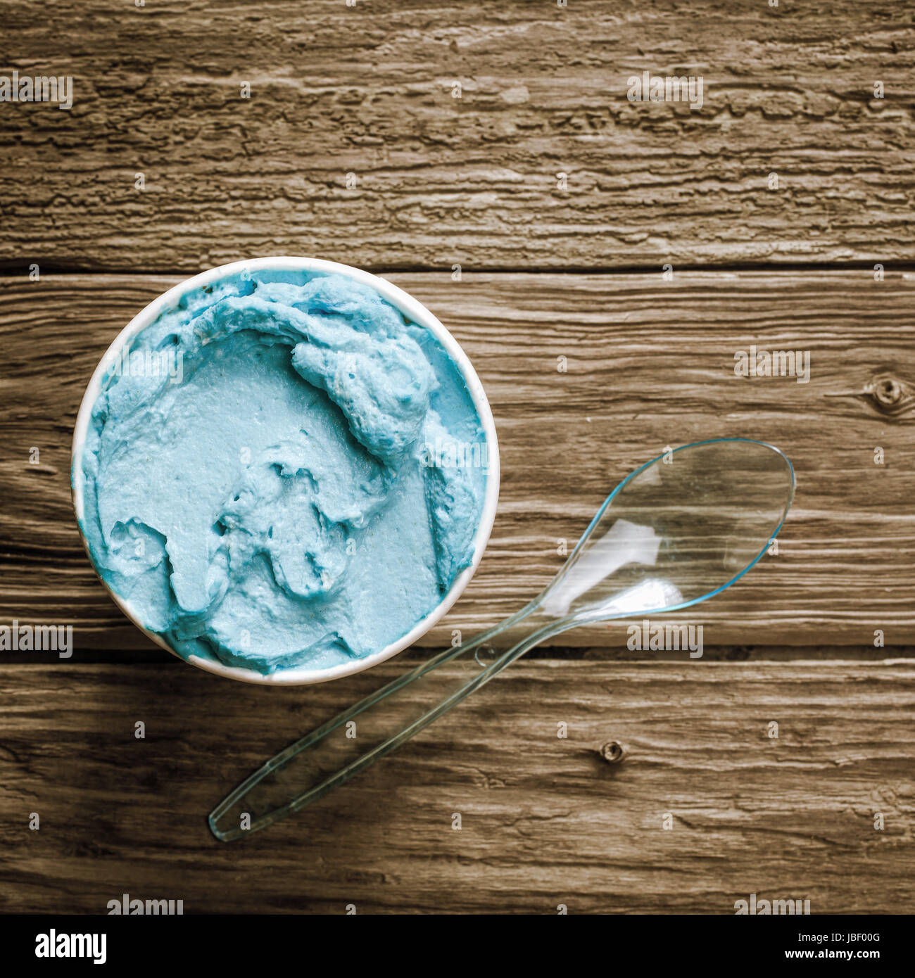 Close up overhead view of a tub of gourmet blue Italian ice cream with ...