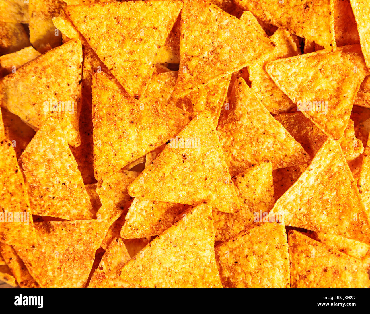 Background of crisp crunchy spicy corn tortillas or nachos with their ...