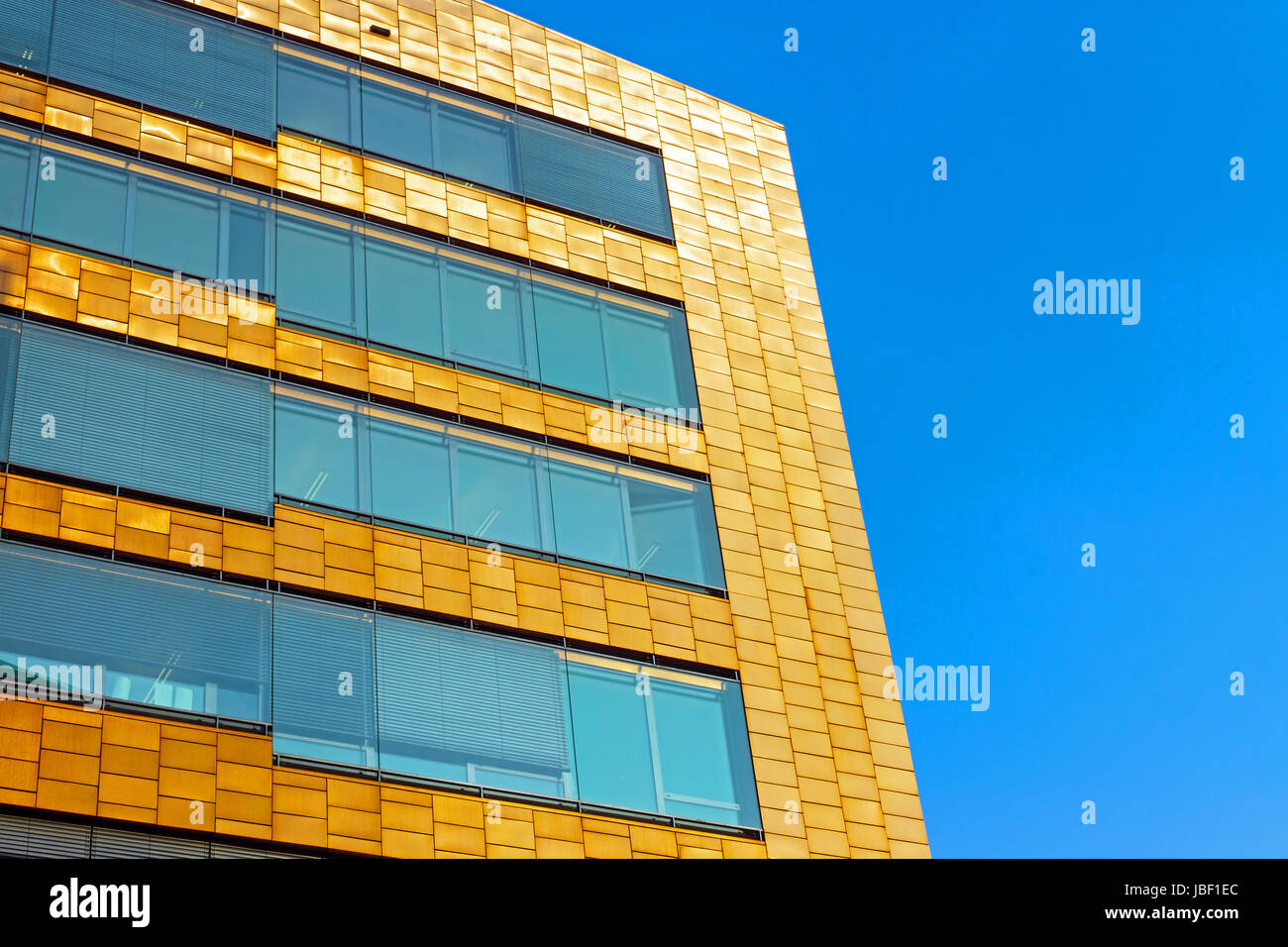 office building with golden facade Stock Photo - Alamy