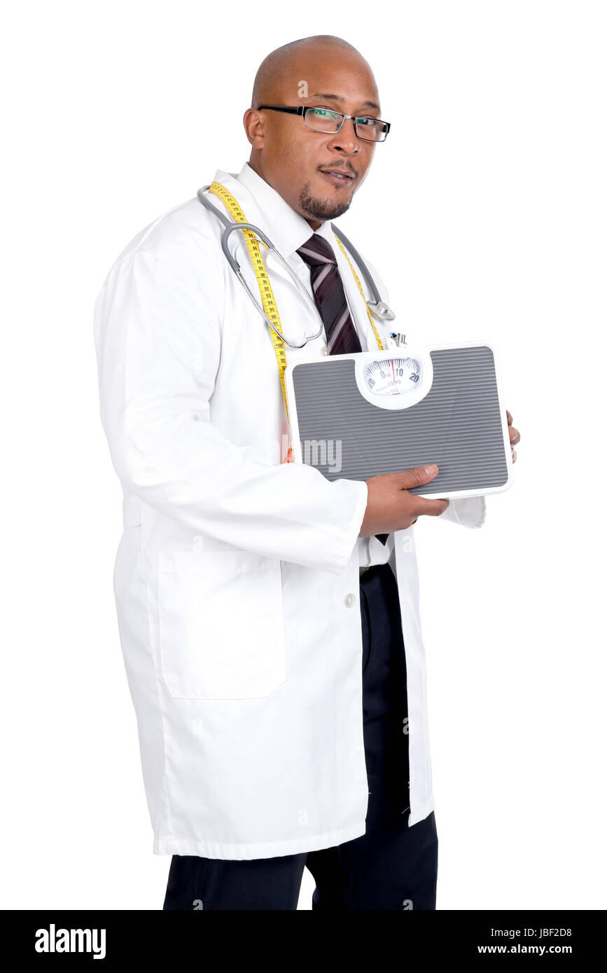 Dark doctor posing with weight scale and measuring tape Stock Photo - Alamy