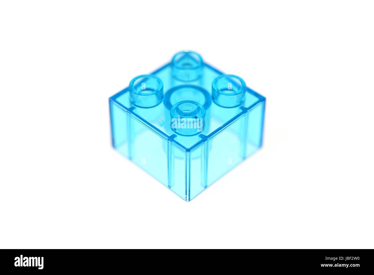 A building block isolated against a white background Stock Photo - Alamy