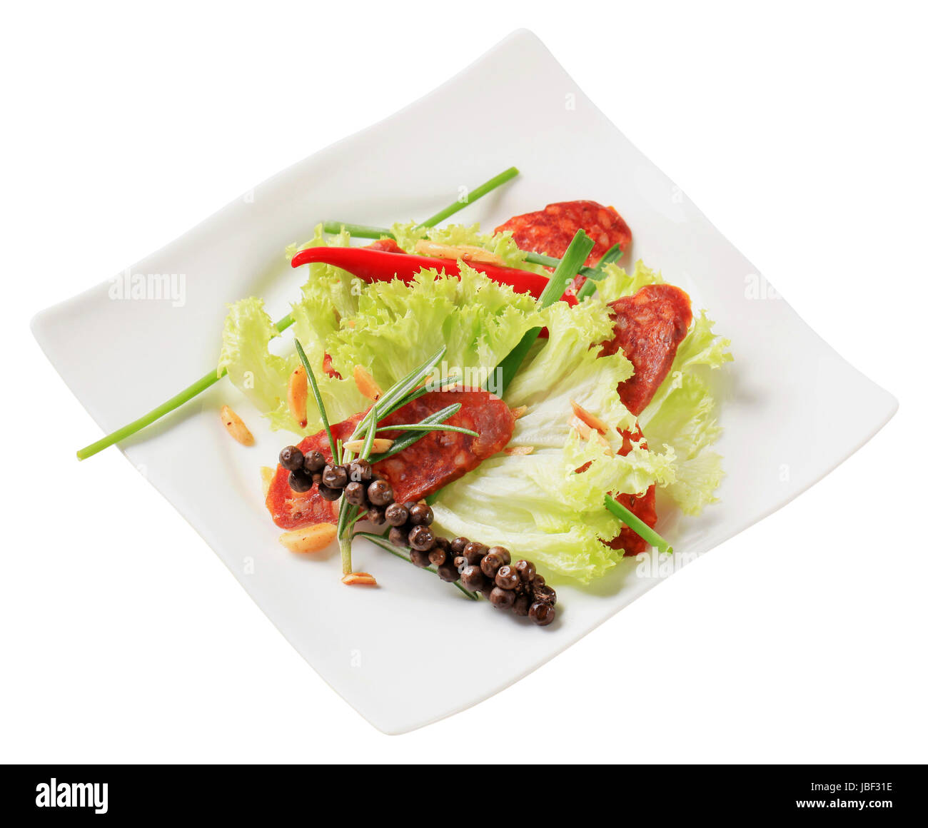 Fresh lettuce and slices of spicy sausage Stock Photo - Alamy