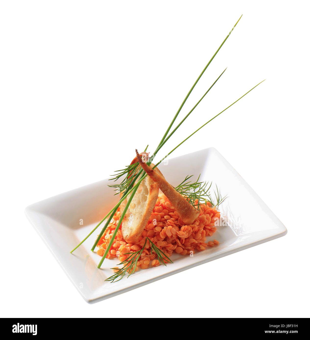 Red lentil salad and pieces of crispy bread Stock Photo - Alamy