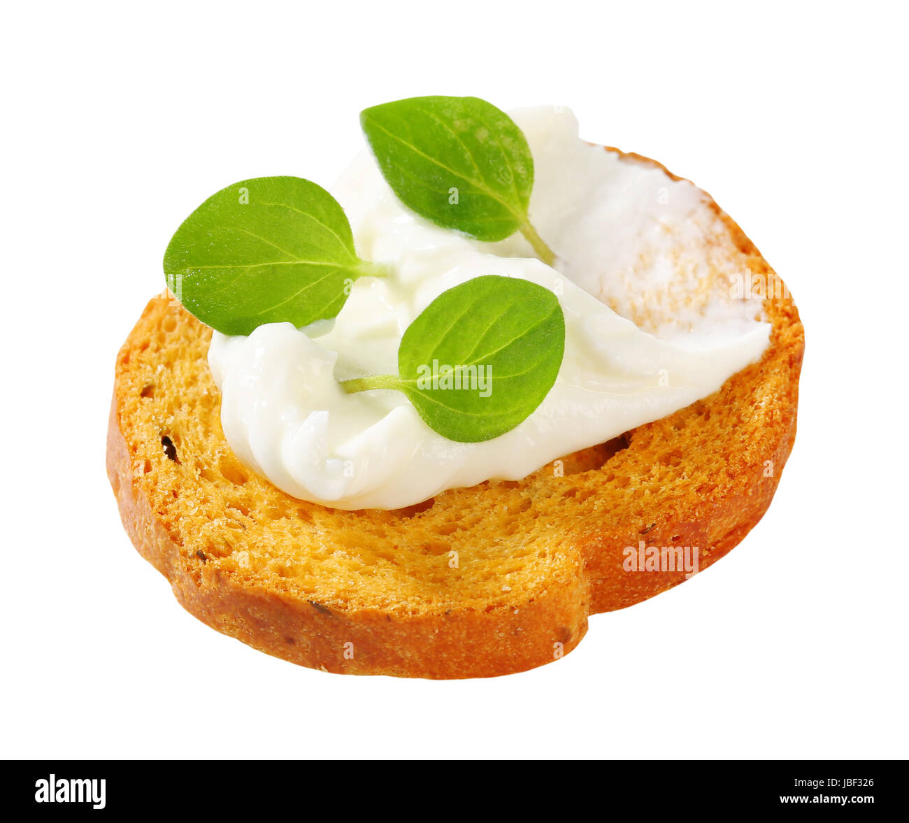 Small round toast with cheese spread Stock Photo - Alamy