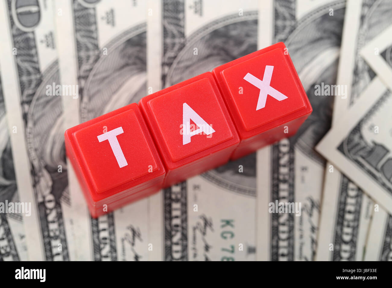 Tax block on money background Stock Photo - Alamy