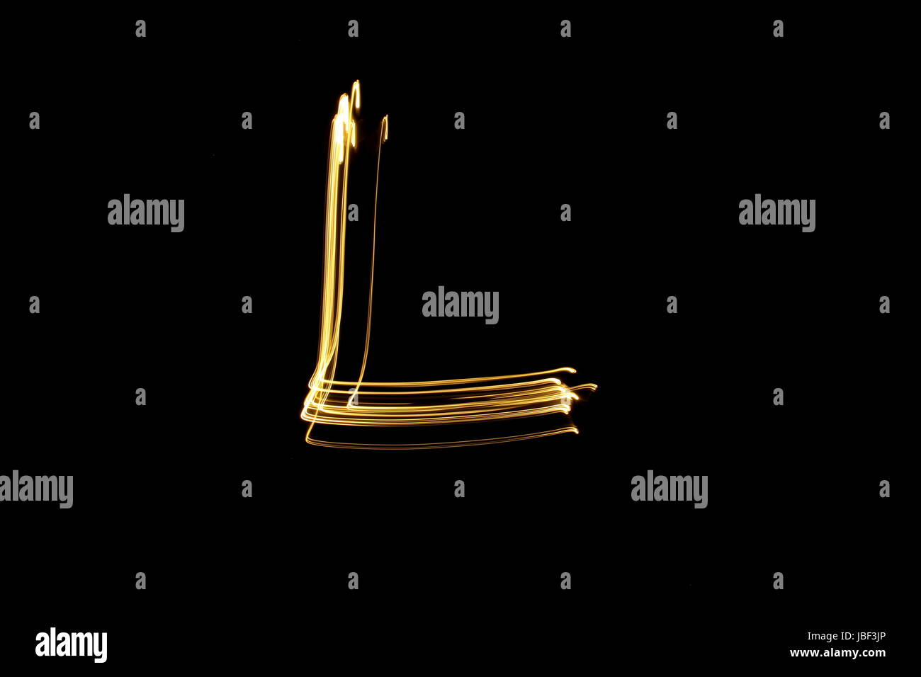 Gold letter L, Light Painting Photography, alphabet series, against a ...