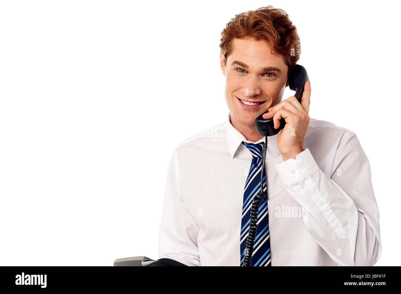 Handsome male executive attending phone call Stock Photo - Alamy