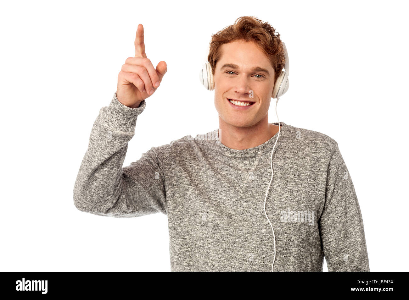 Guy enjoying music isolated over white Stock Photo - Alamy