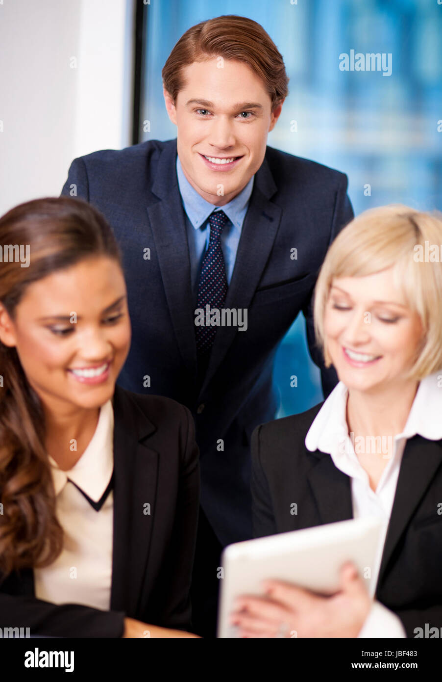 Team of friendly business people at work Stock Photo - Alamy