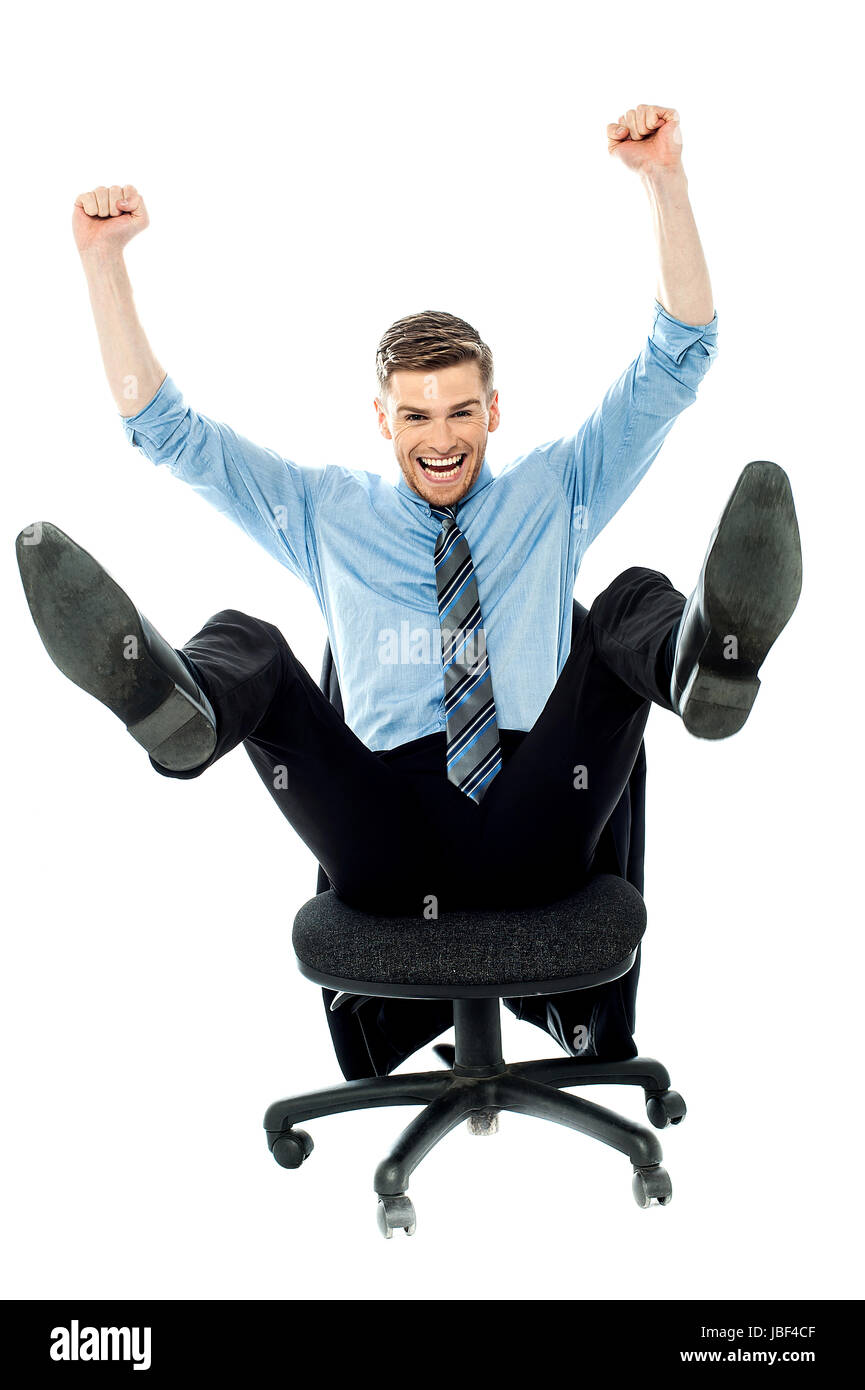 Excited businessman raising his hands and legs Stock Photo - Alamy