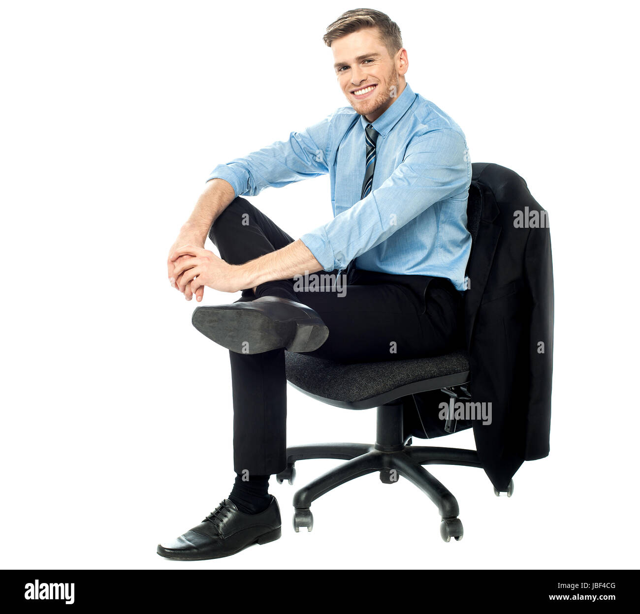 Young manager sitting on revolving chair Stock Photo - Alamy
