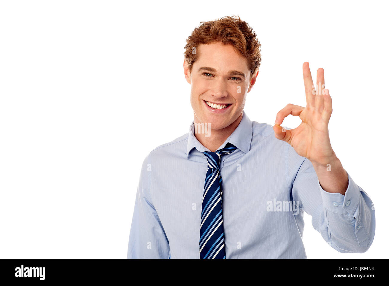 Handsome young businessman showing perfect gesture Stock Photo - Alamy