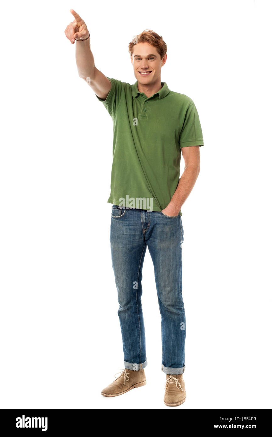 Fashion guy pointing at something over white Stock Photo - Alamy