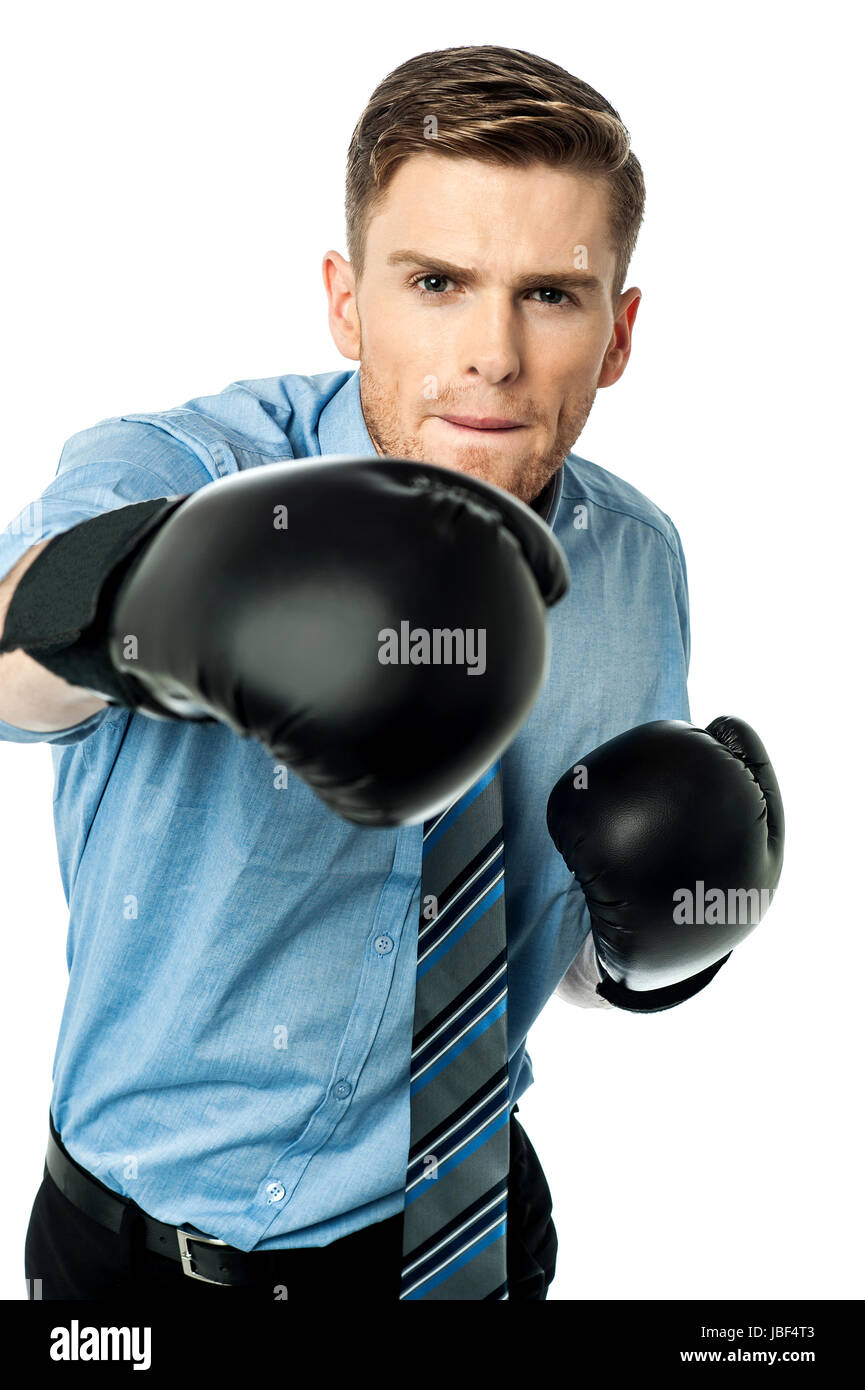 Businessman in punching posture Stock Photo - Alamy