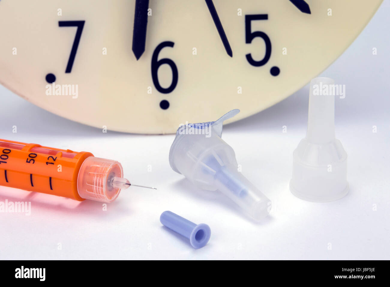 medicine vials and syringe, the clock shows the time of the medication ...
