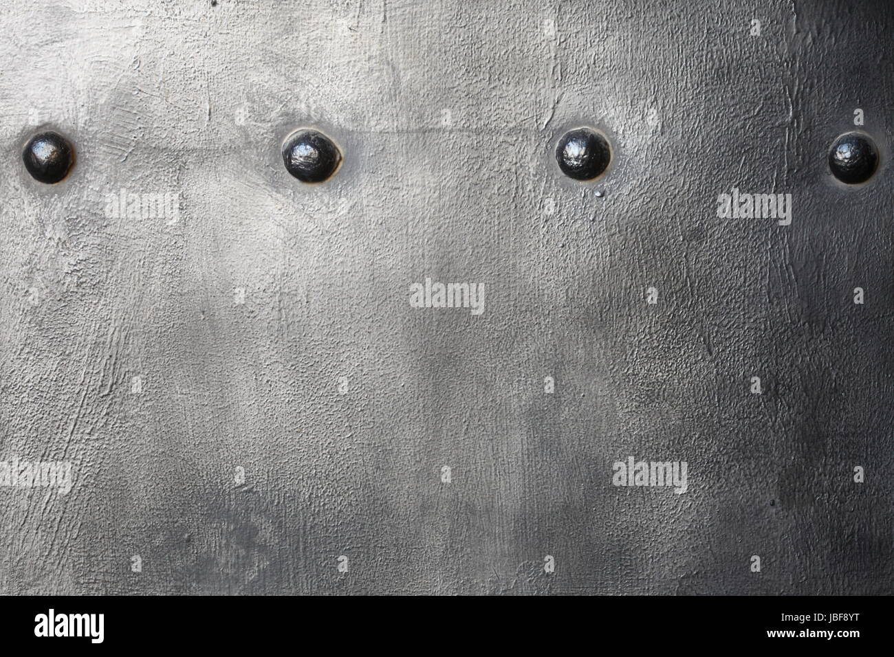 Black grunge metal plate or armour texture with rivets as background ...