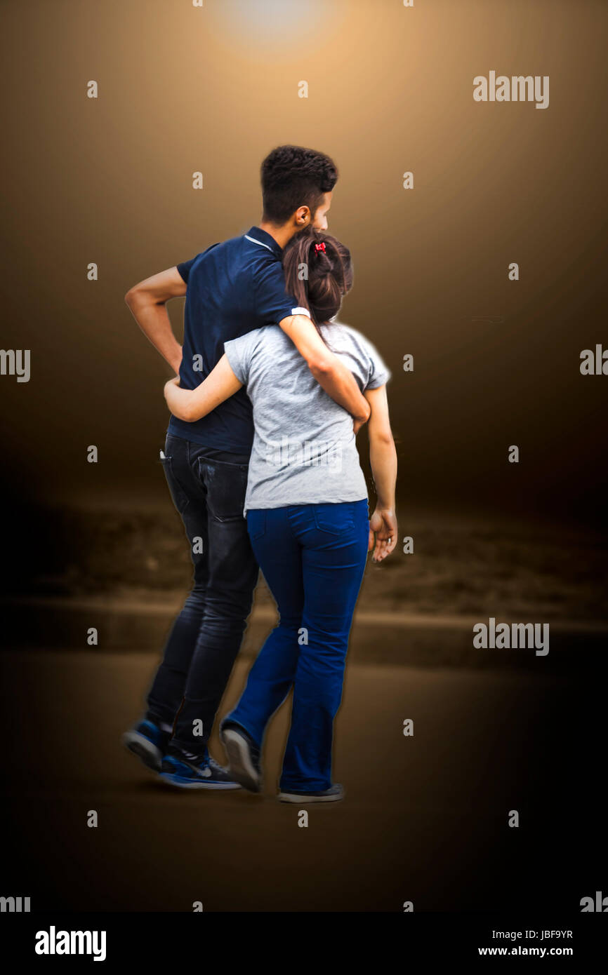 Boy and girl walking hugged on the street Stock Photo - Alamy