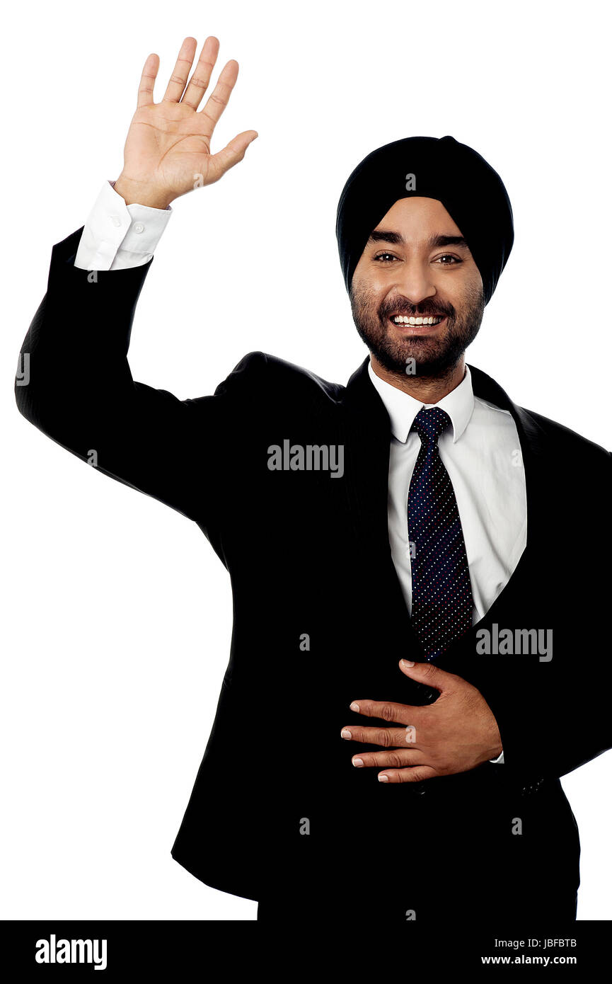 Handsome Indian male manager waving Stock Photo - Alamy