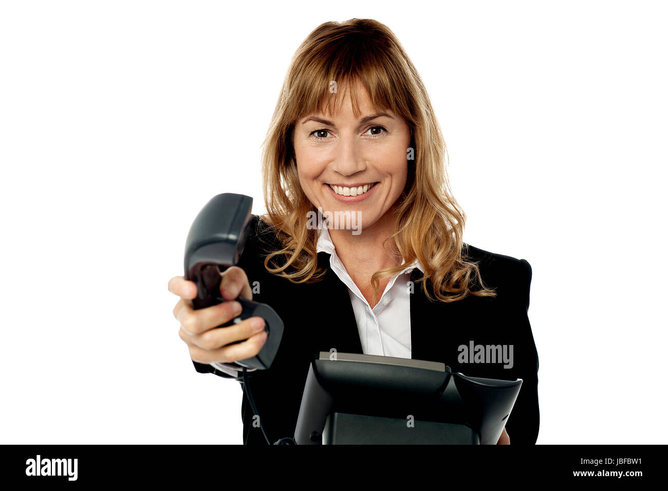 Female assistant handing over phone receiver Stock Photo - Alamy