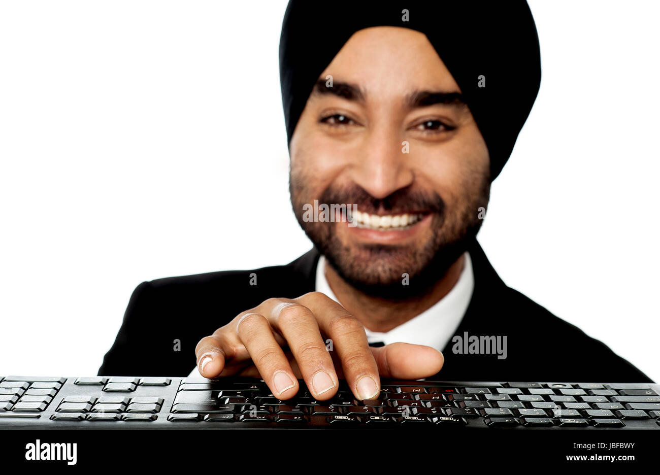 Smiling manager typing on computer keyboard Stock Photo - Alamy