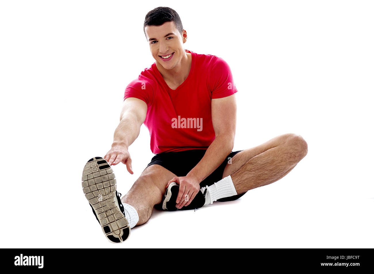 Young man doing stretching exercise isolated on white Stock Photo - Alamy