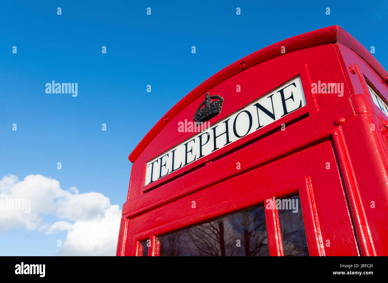 classic red uk telephone box against a blue sky Stock Photo - Alamy