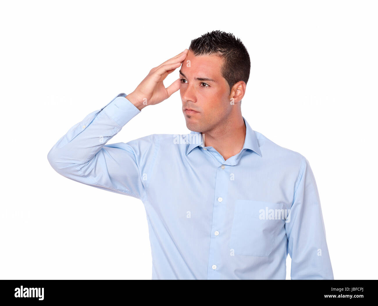 Portrait of a stressed young man with head pain standing while is ...
