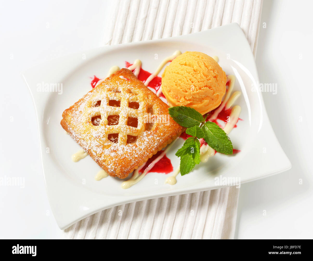 Little apricot pie with ice cream and drizzle sauce Stock Photo - Alamy