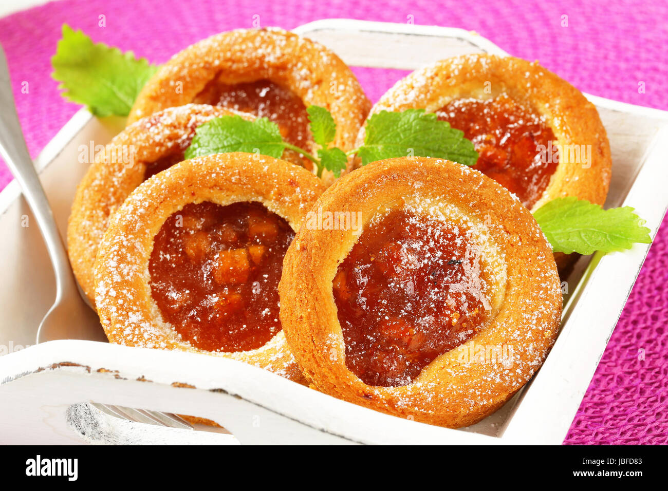 Small round cakes filled with apple puree Stock Photo - Alamy