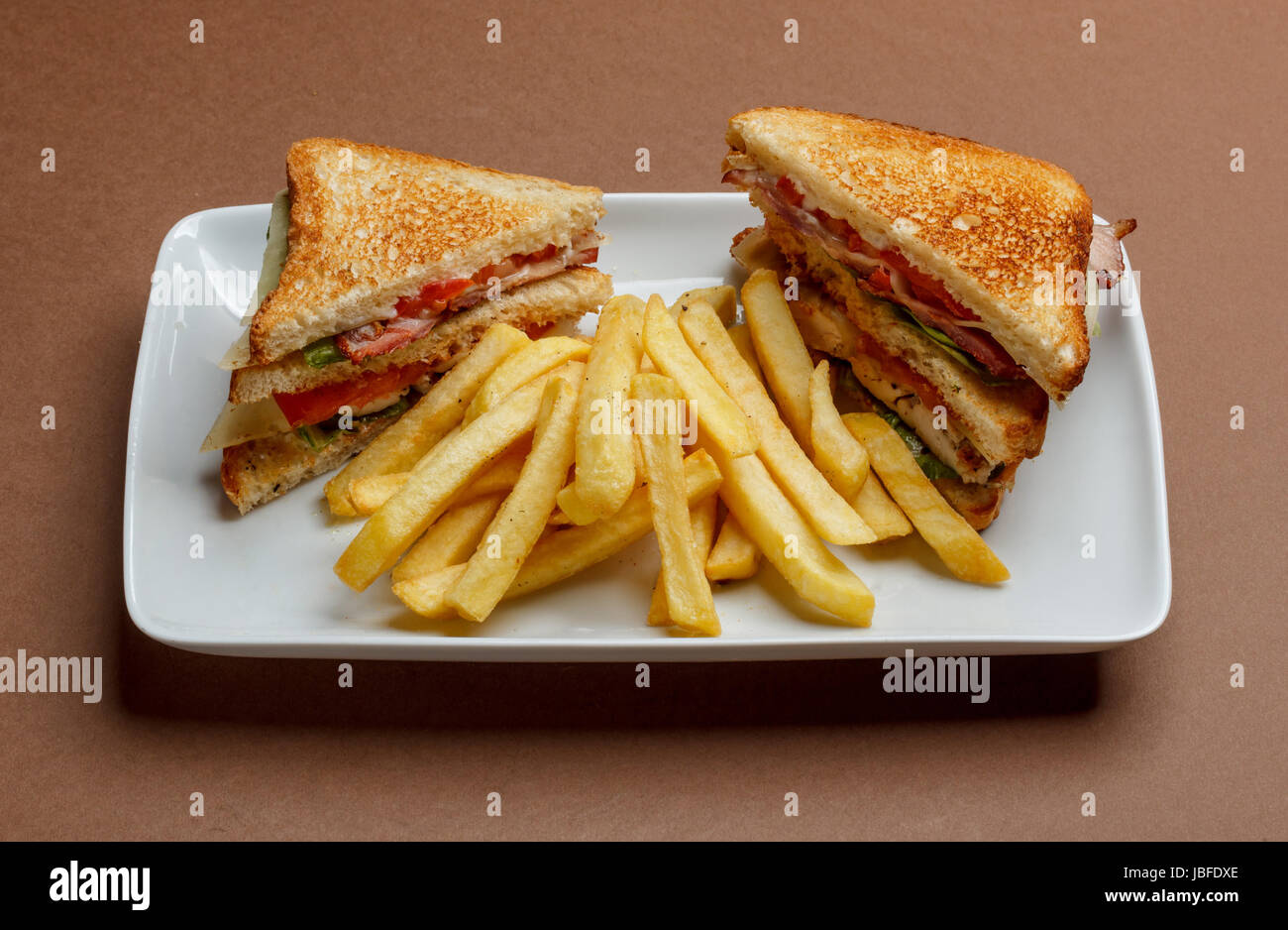Delicious club sandwich with french fries Stock Photo - Alamy