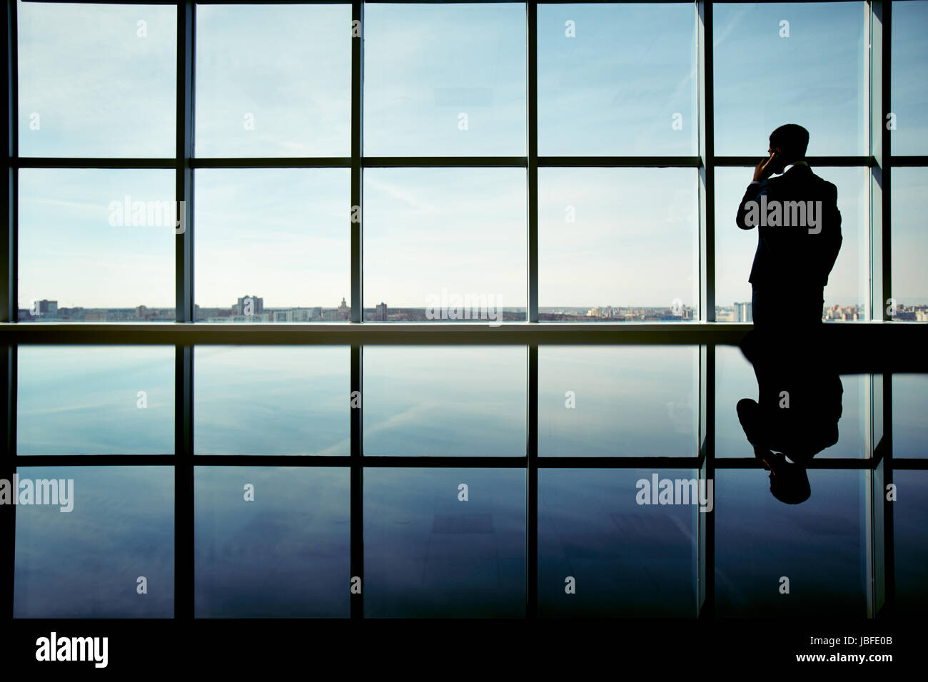 Outline of office worker speaking on the phone by the window Stock ...