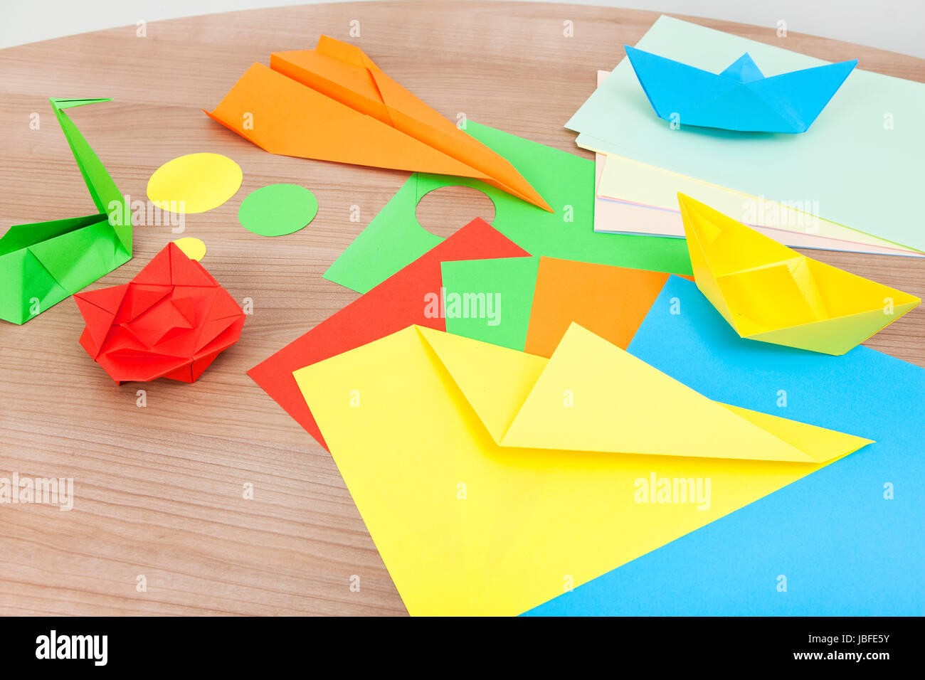 colorful paper lying on a table to fold of objects Stock Photo - Alamy