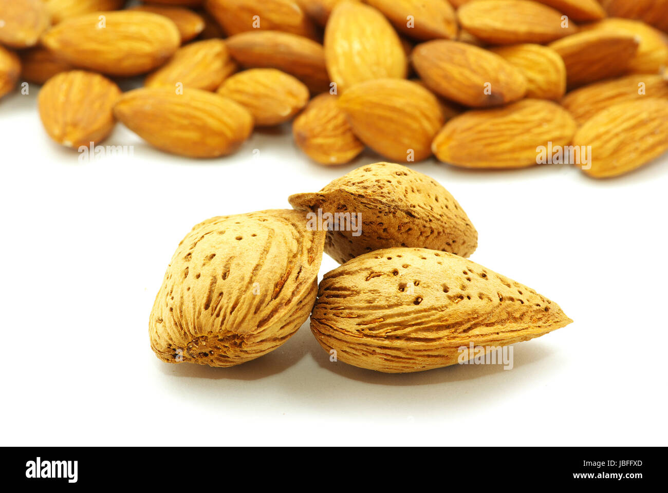 Almond nuts isolated on a white background Stock Photo - Alamy