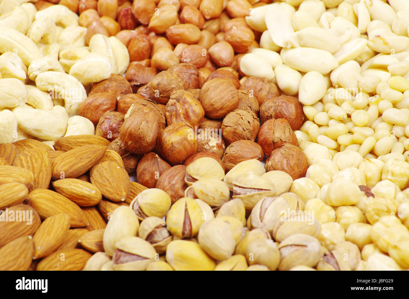 mixed nuts on a background Stock Photo - Alamy