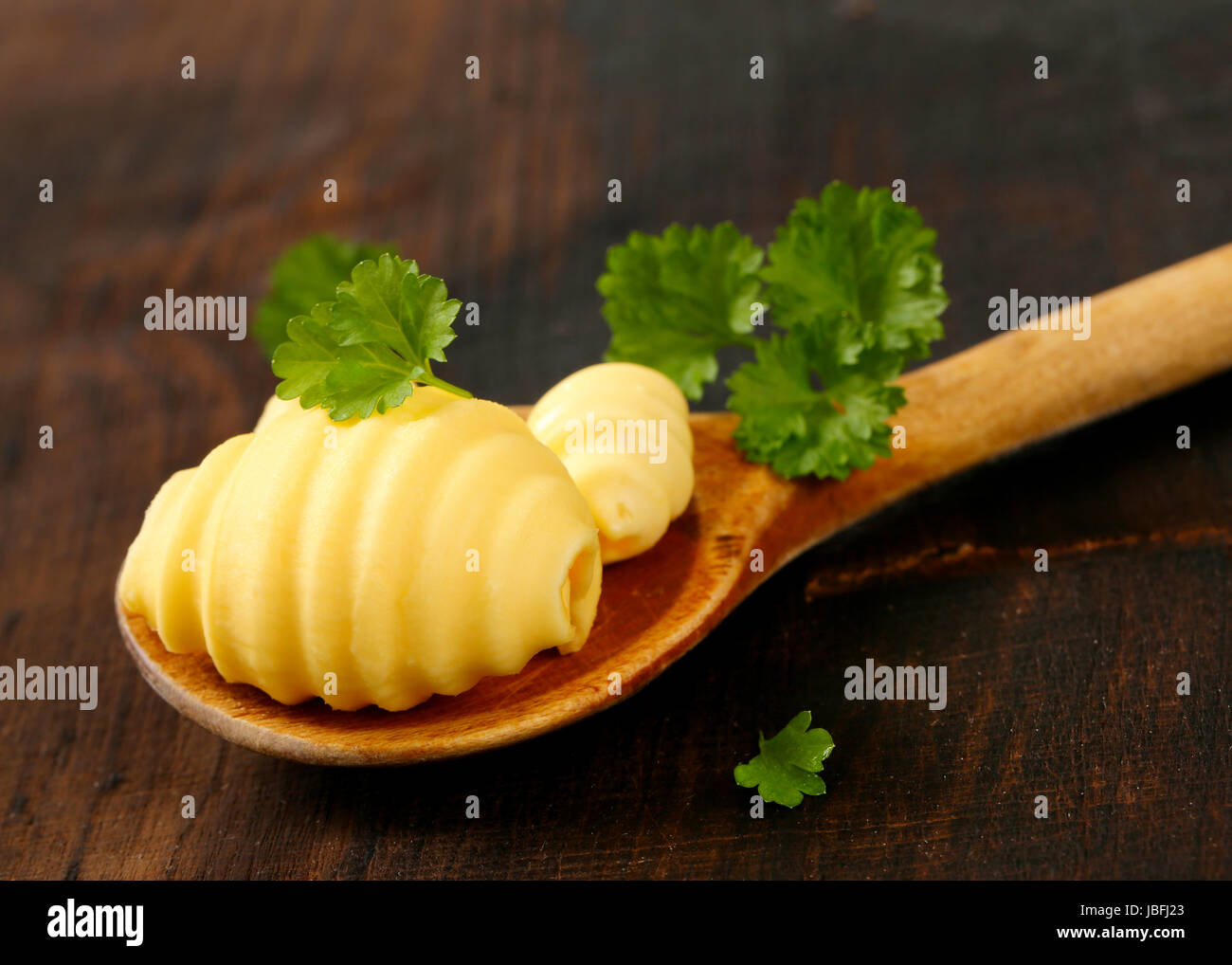 Butter curls on wooden spoon Stock Photo - Alamy