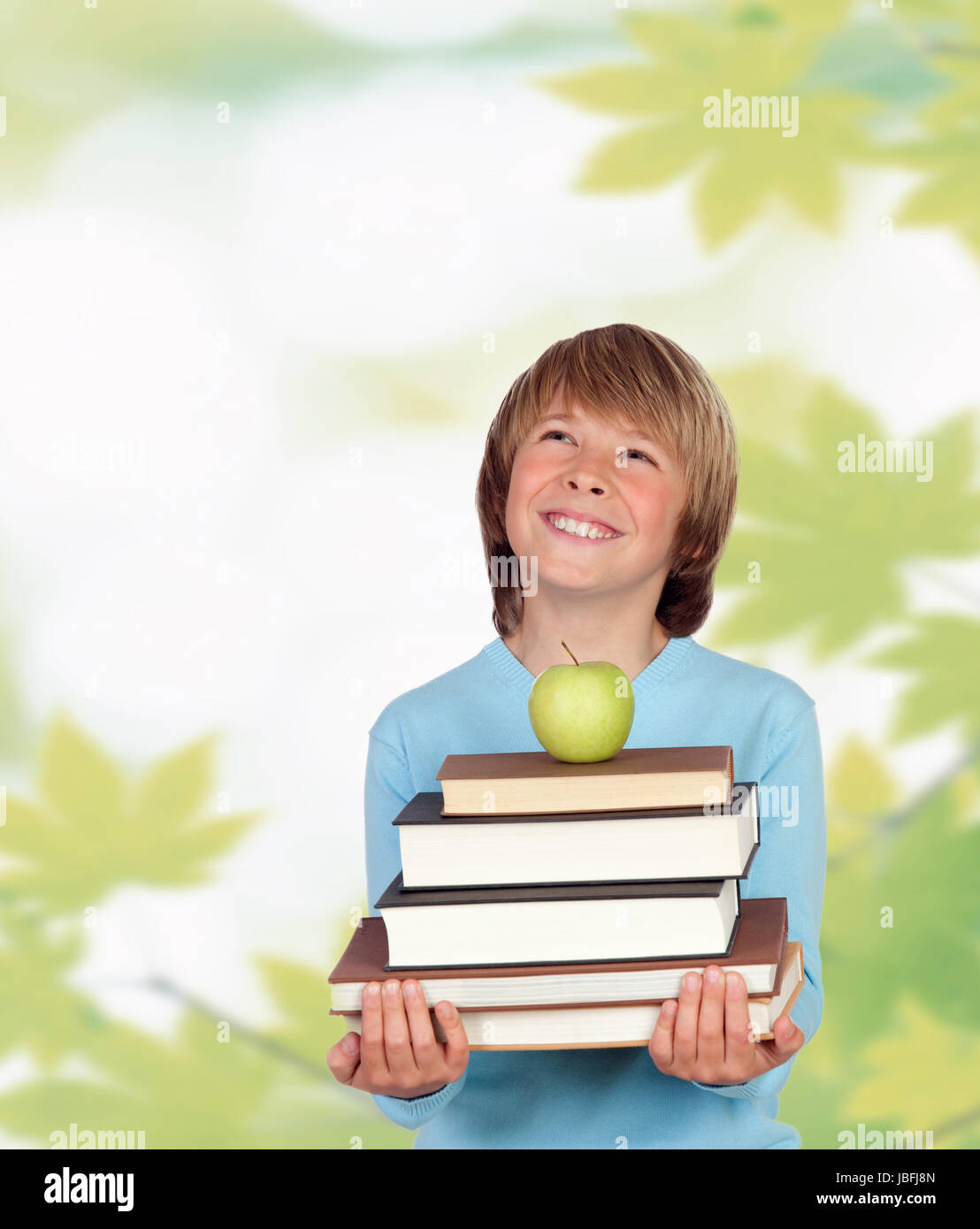Funny child with many books and leaves of background Stock Photo - Alamy