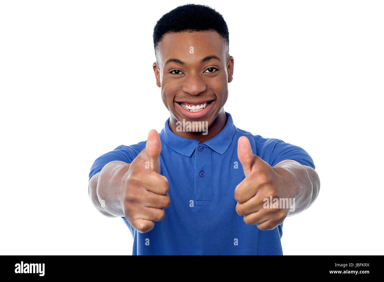 Smart young man showing double thumbs up Stock Photo - Alamy