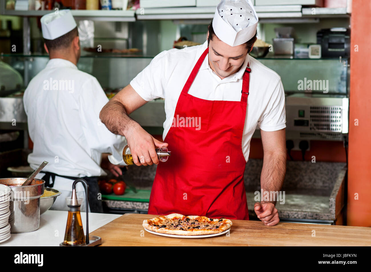 Male chefs working in kitchen, back-office shot Stock Photo - Alamy