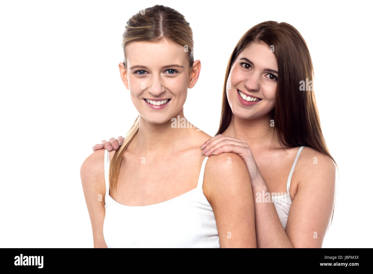Smiling attractive friends wearing sleeveless spaghetti and posing ...