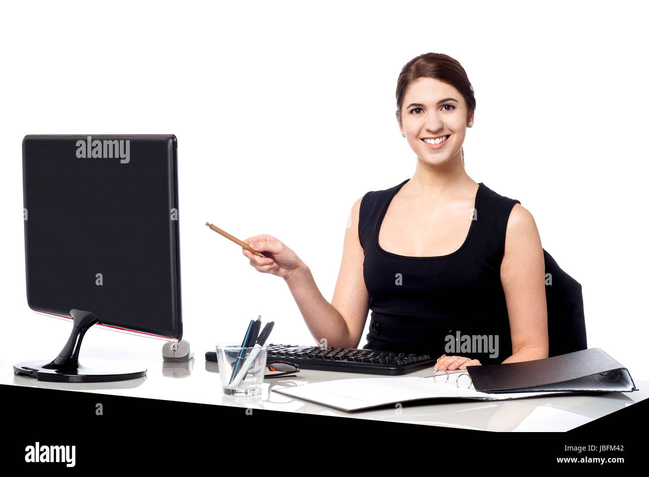 Pretty businesswoman pointing something at monitor Stock Photo - Alamy
