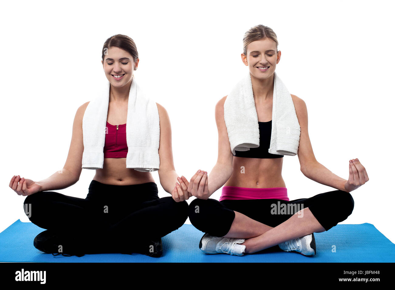 Beautiful young women doing meditation at fitness center Stock Photo ...